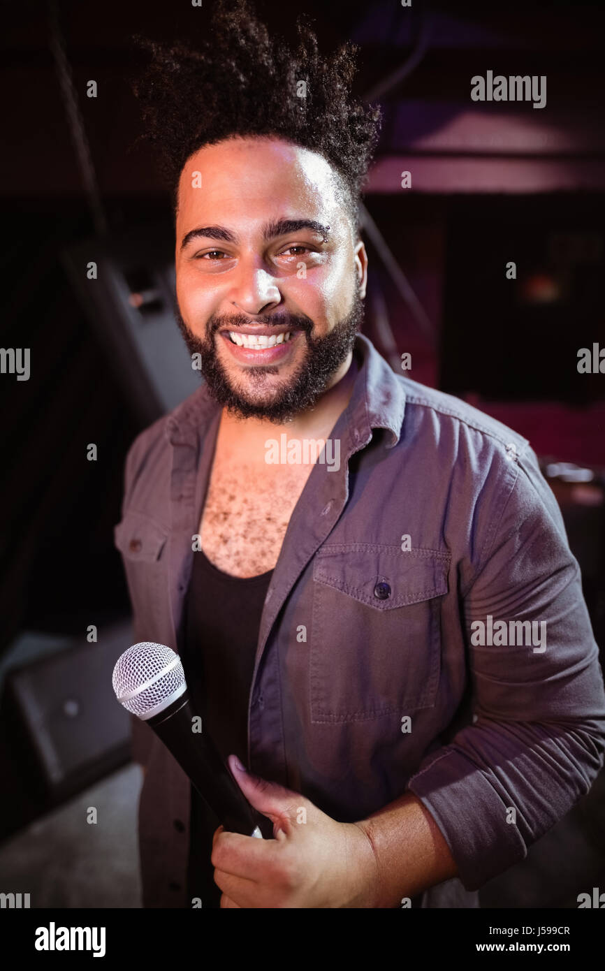 Portrait of singer holding mic at nightclub during music festival Stock ...