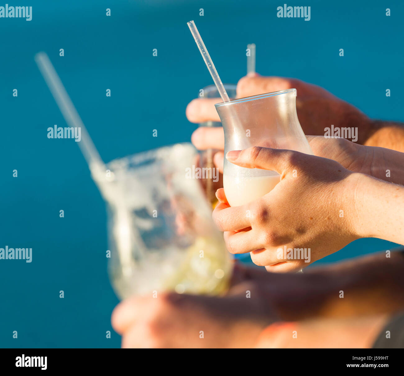 People drinking cocktails outside at a party Stock Photo - Alamy