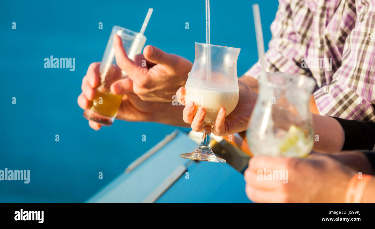 People drinking cocktails outside at a party Stock Photo - Alamy