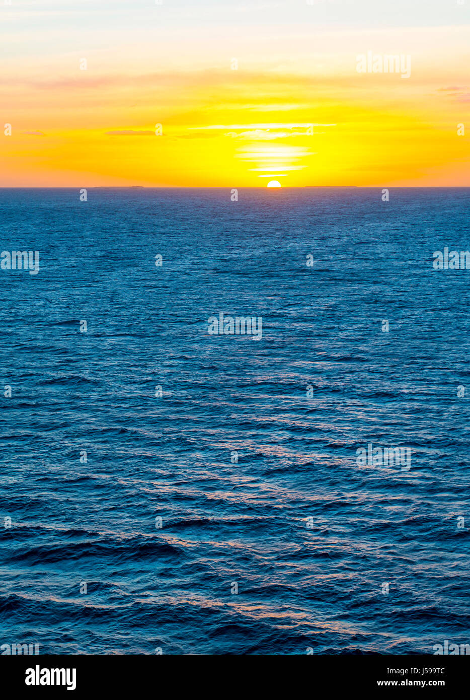 Sunset over the sea with horizon line and gentle ocean waves Stock ...