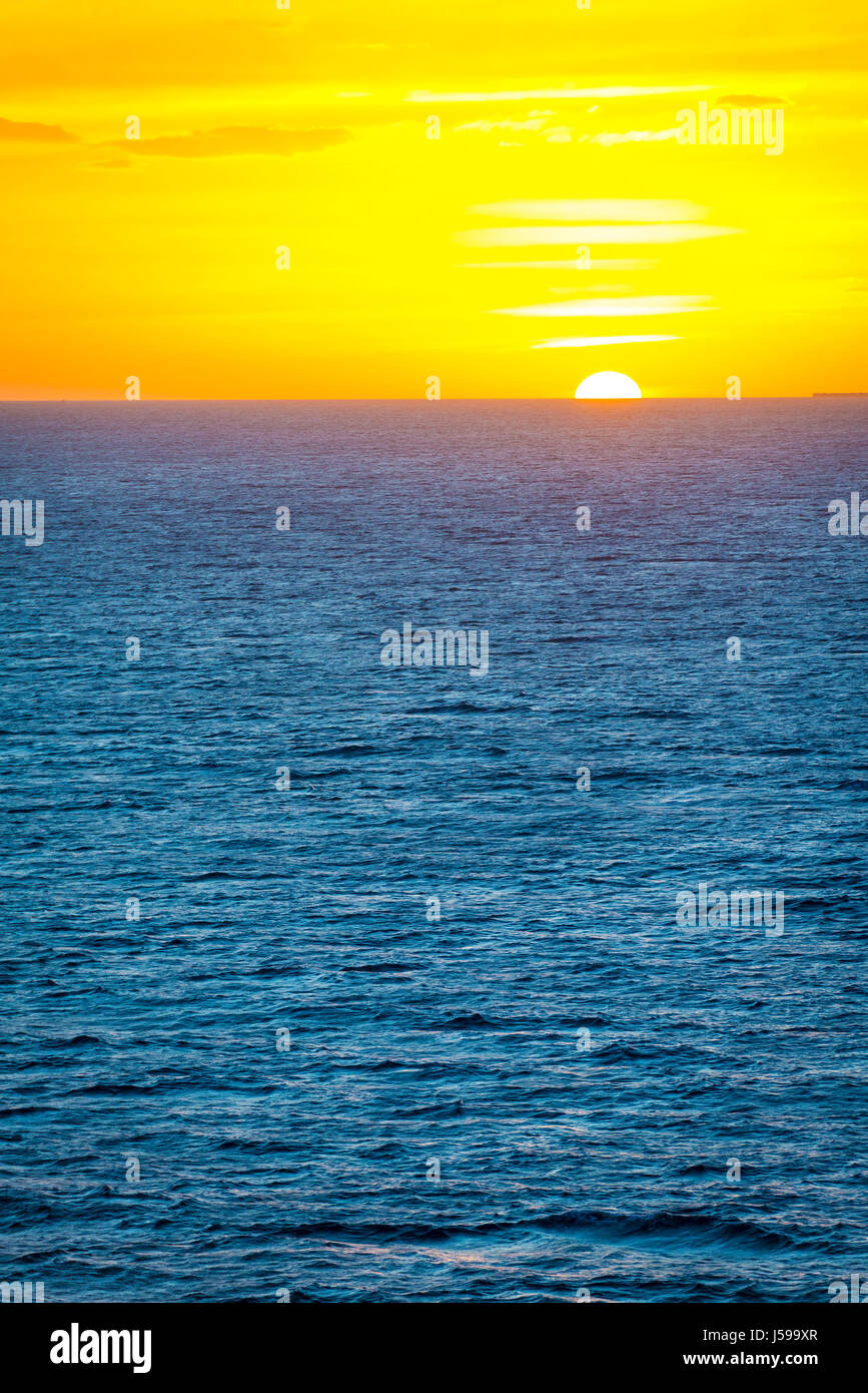 Sunset over the sea with horizon line and gentle ocean waves Stock ...
