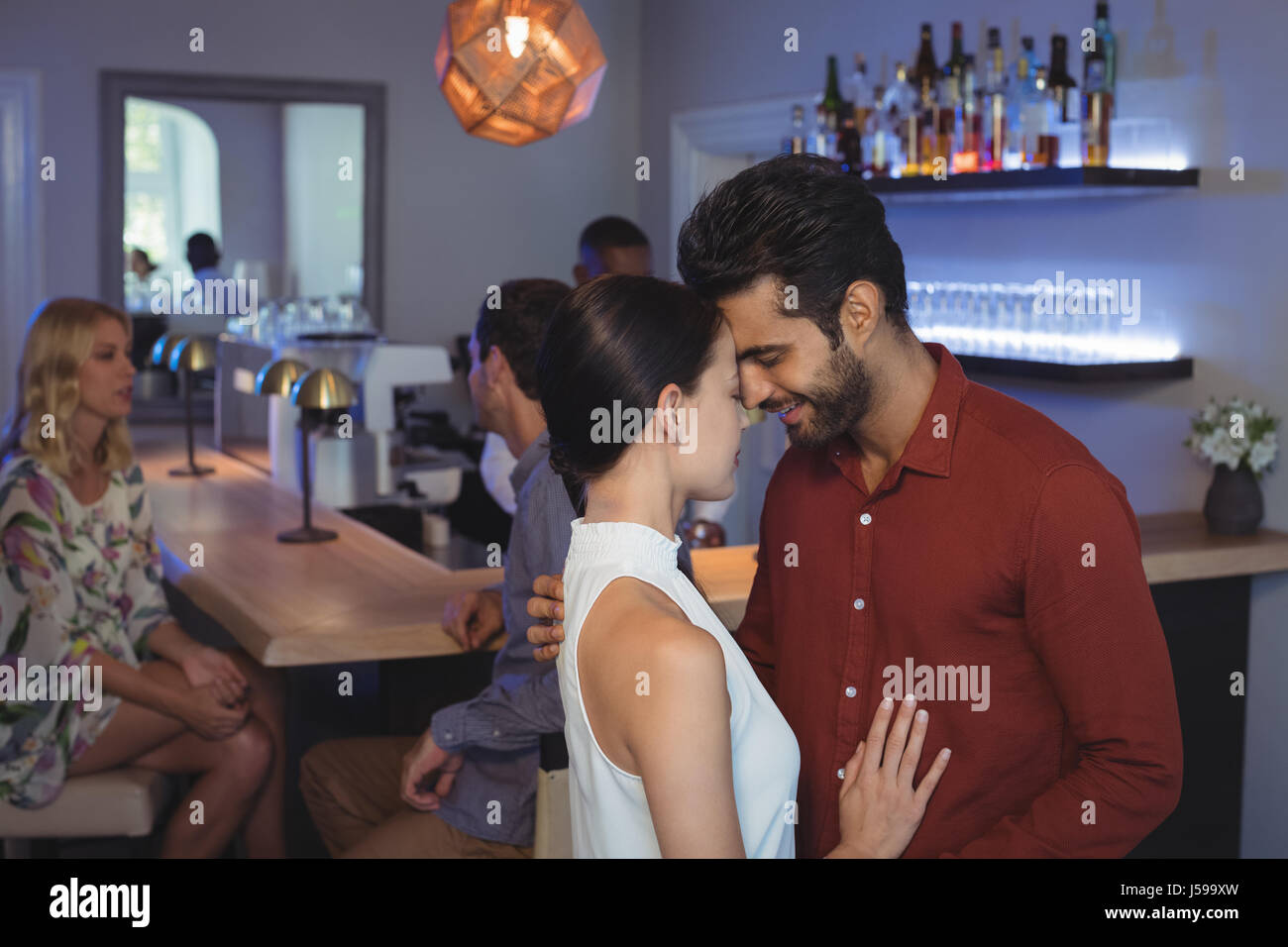 Romantic couple embracing each other at bar restaurant Stock Photo - Alamy