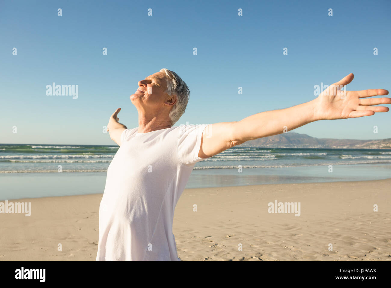 Man standing with arms up hi-res stock photography and images - Alamy