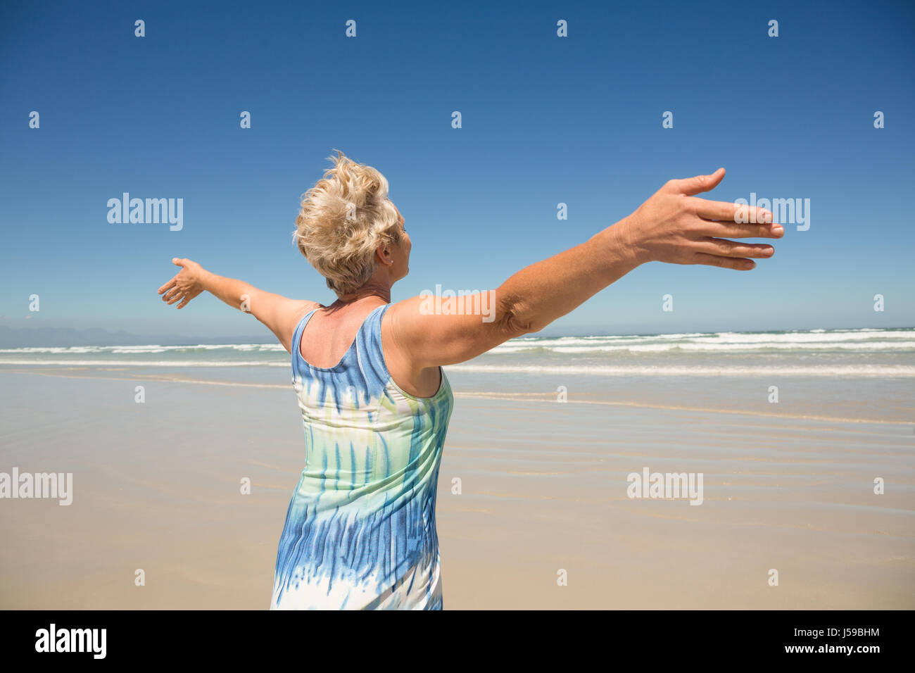 Woman arms raised rear view sky hi-res stock photography and images - Alamy