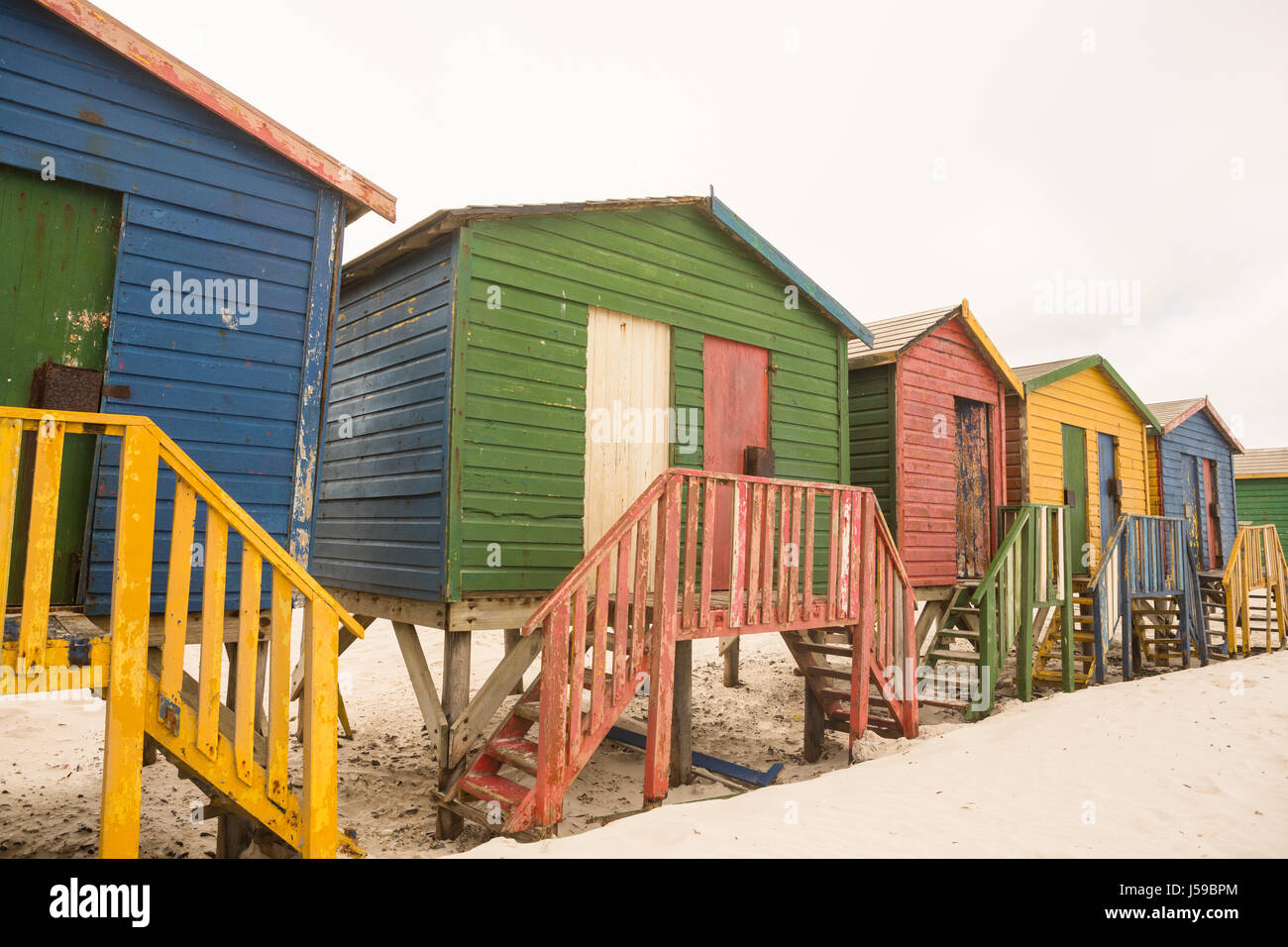 Wooden colorful huts on sand against clear sky Stock Photo - Alamy