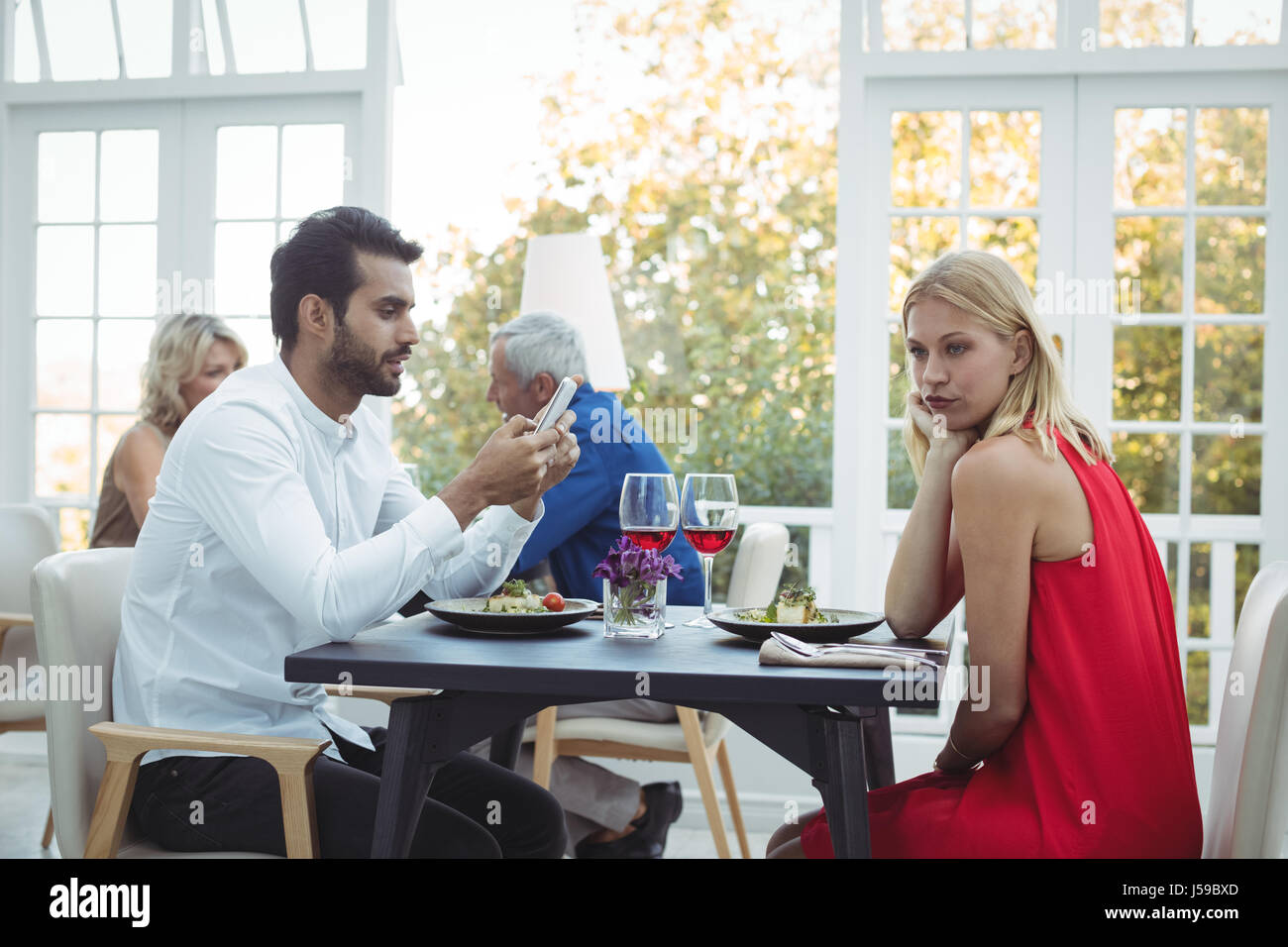 Man thinking sad woman restaurant hi-res stock photography and images ...
