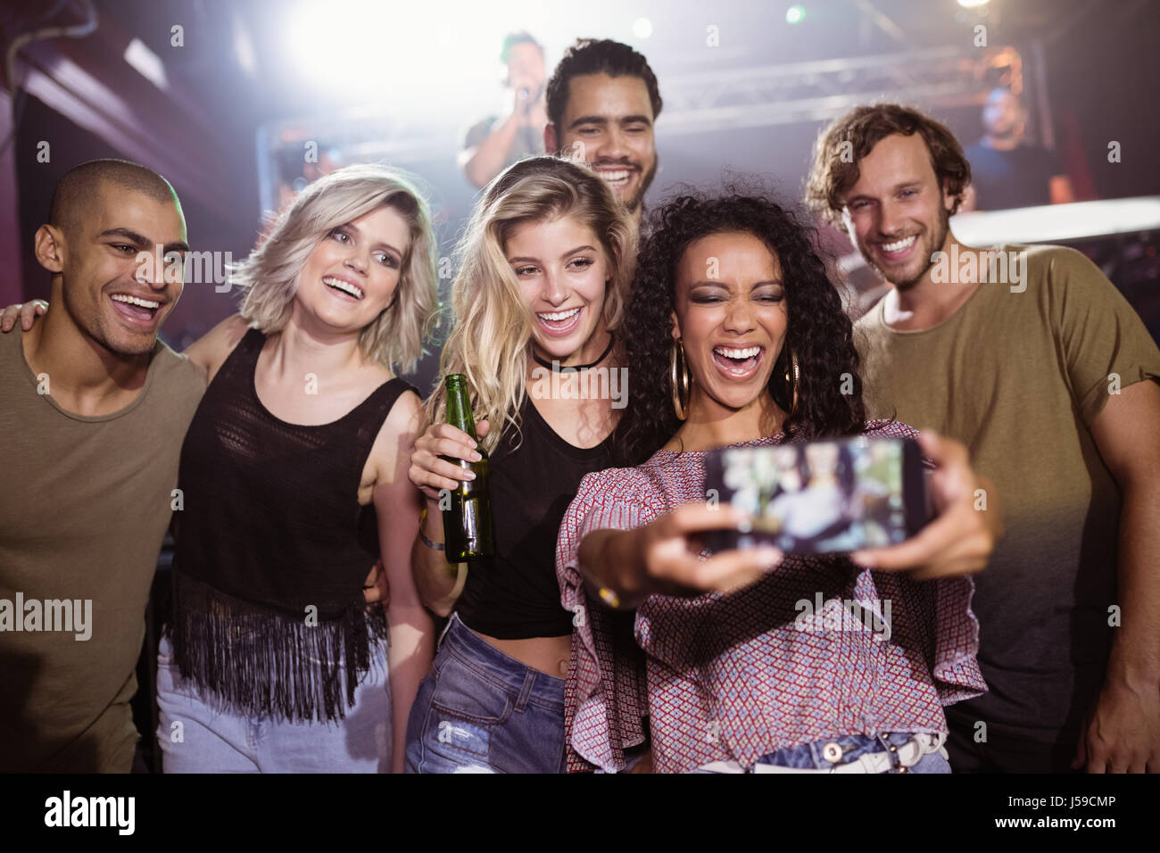 Cheerful young friends talking selfie at nightclub Stock Photo - Alamy