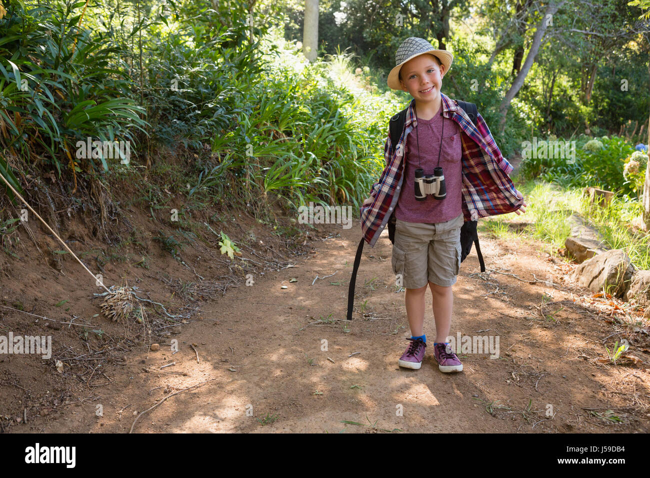 portrait of smiling boy standing in the forest Stock Photo - Alamy
