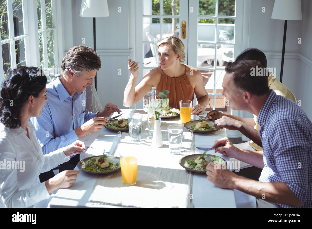 Group of friends having meal in restaurant Stock Photo - Alamy