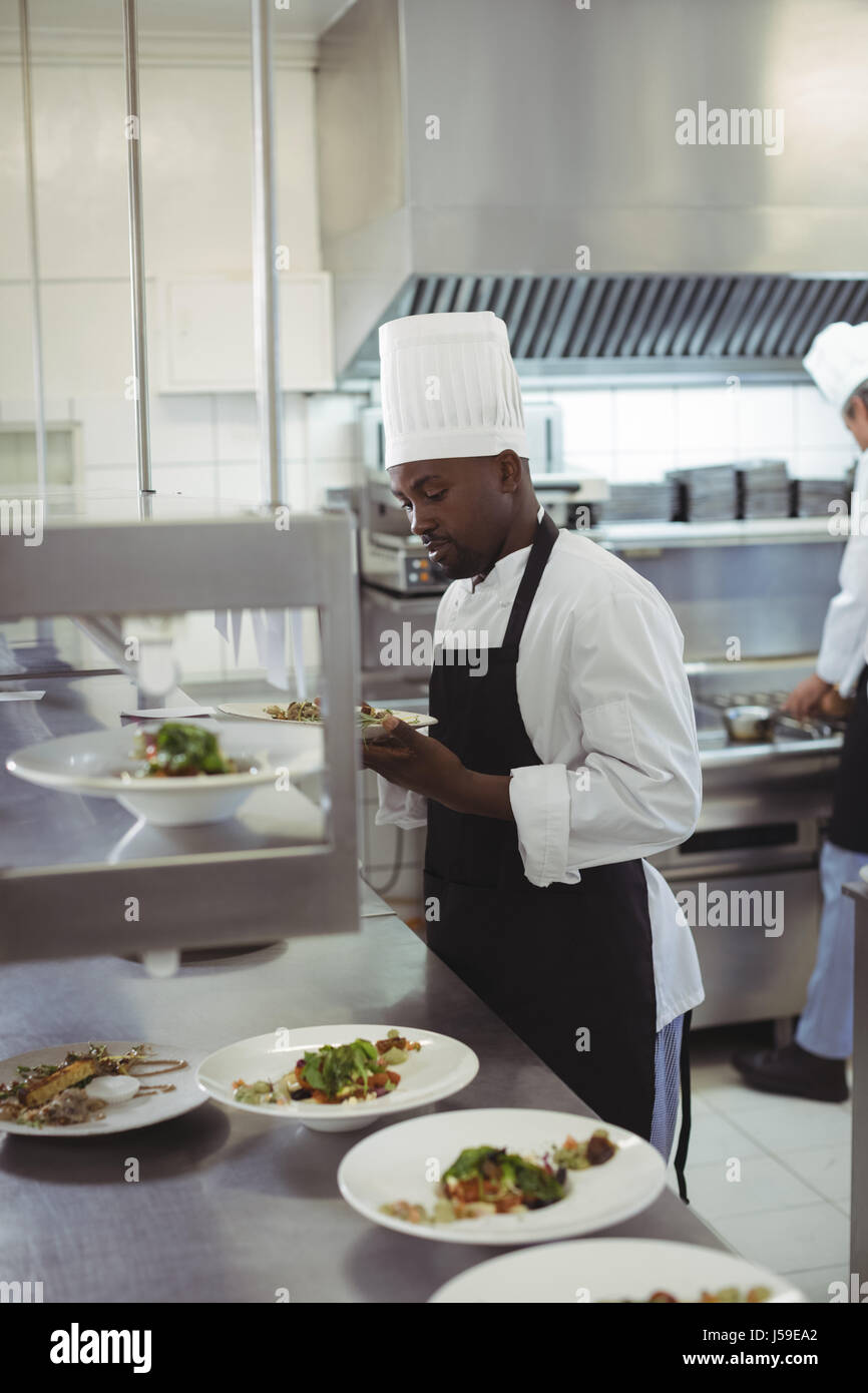 Male chef keeping appetizer plate ready on the order station at ...