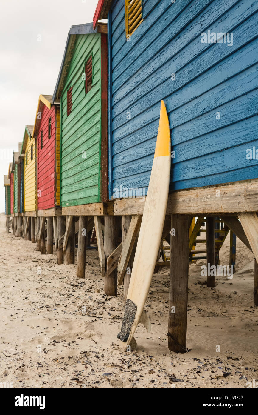 Surfboard by blue wooden hut at beach Stock Photo - Alamy