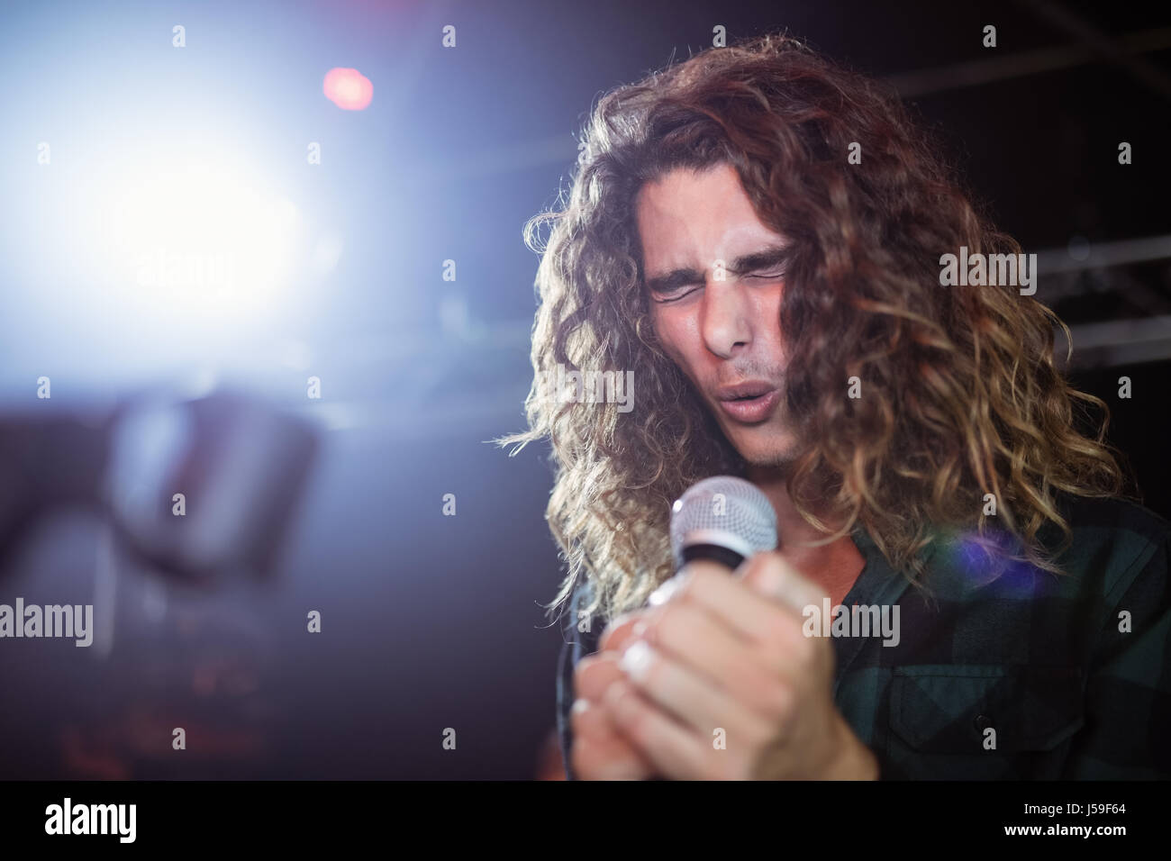 Young male singer performing at nightclub during music festival Stock ...