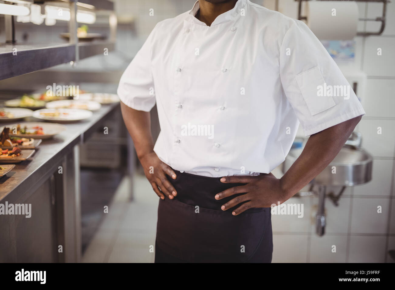 Food and drink preparation standing hands on hip hi-res stock ...