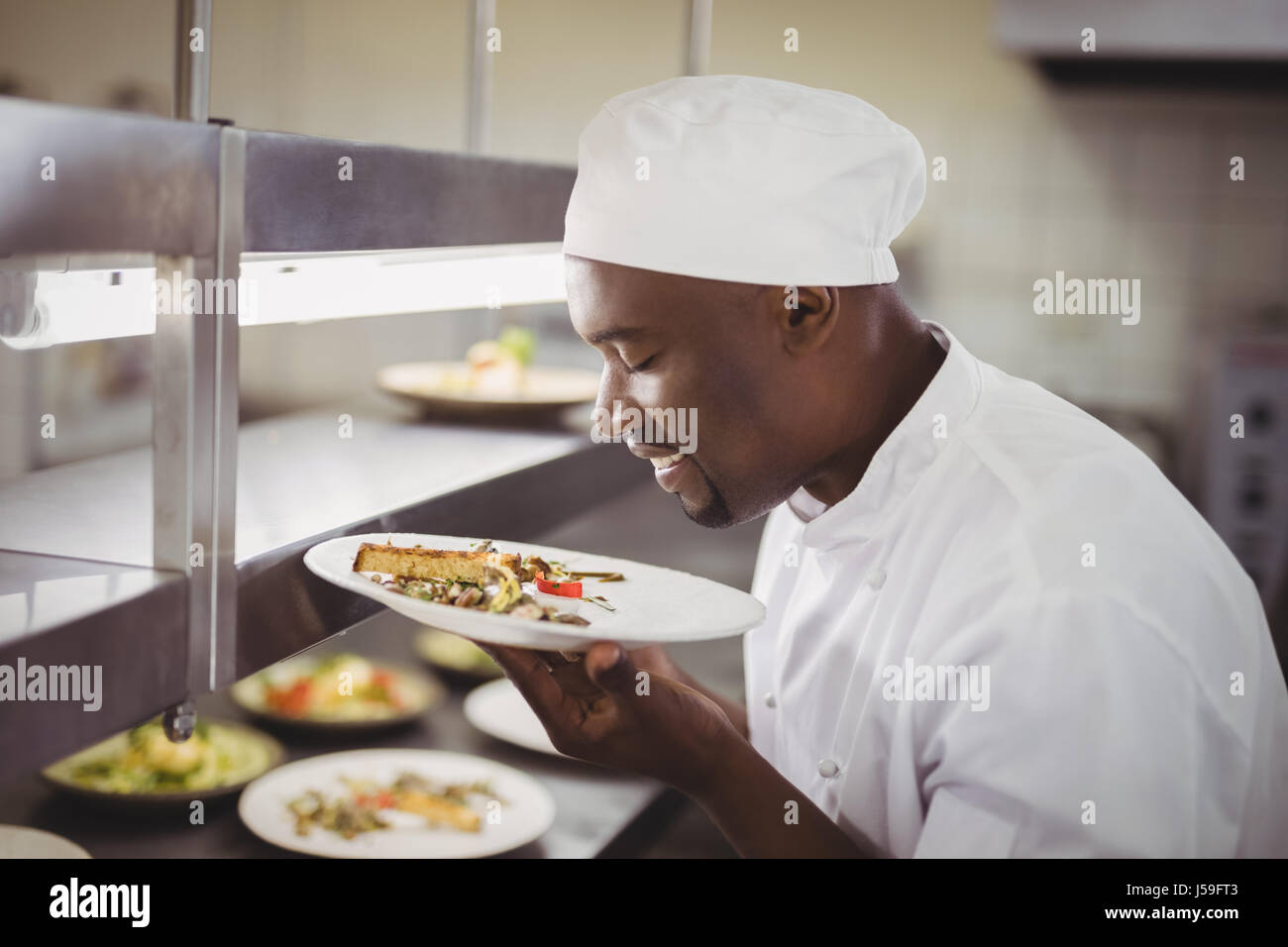 Chef smelling food in commercial kitchen at restaurant Stock Photo - Alamy