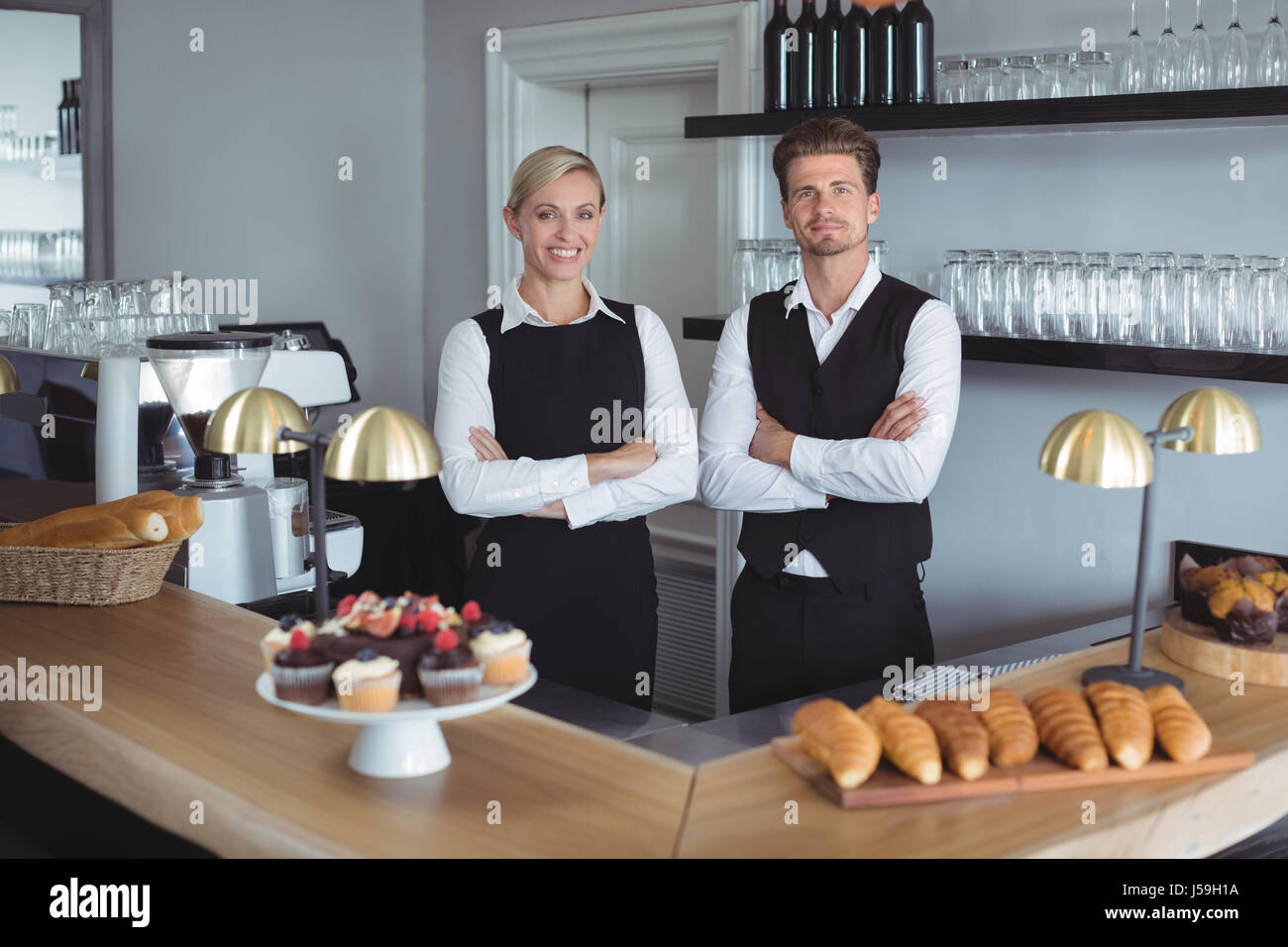 Portrait of waiters smiling at camera in a restaurant Stock Photo - Alamy