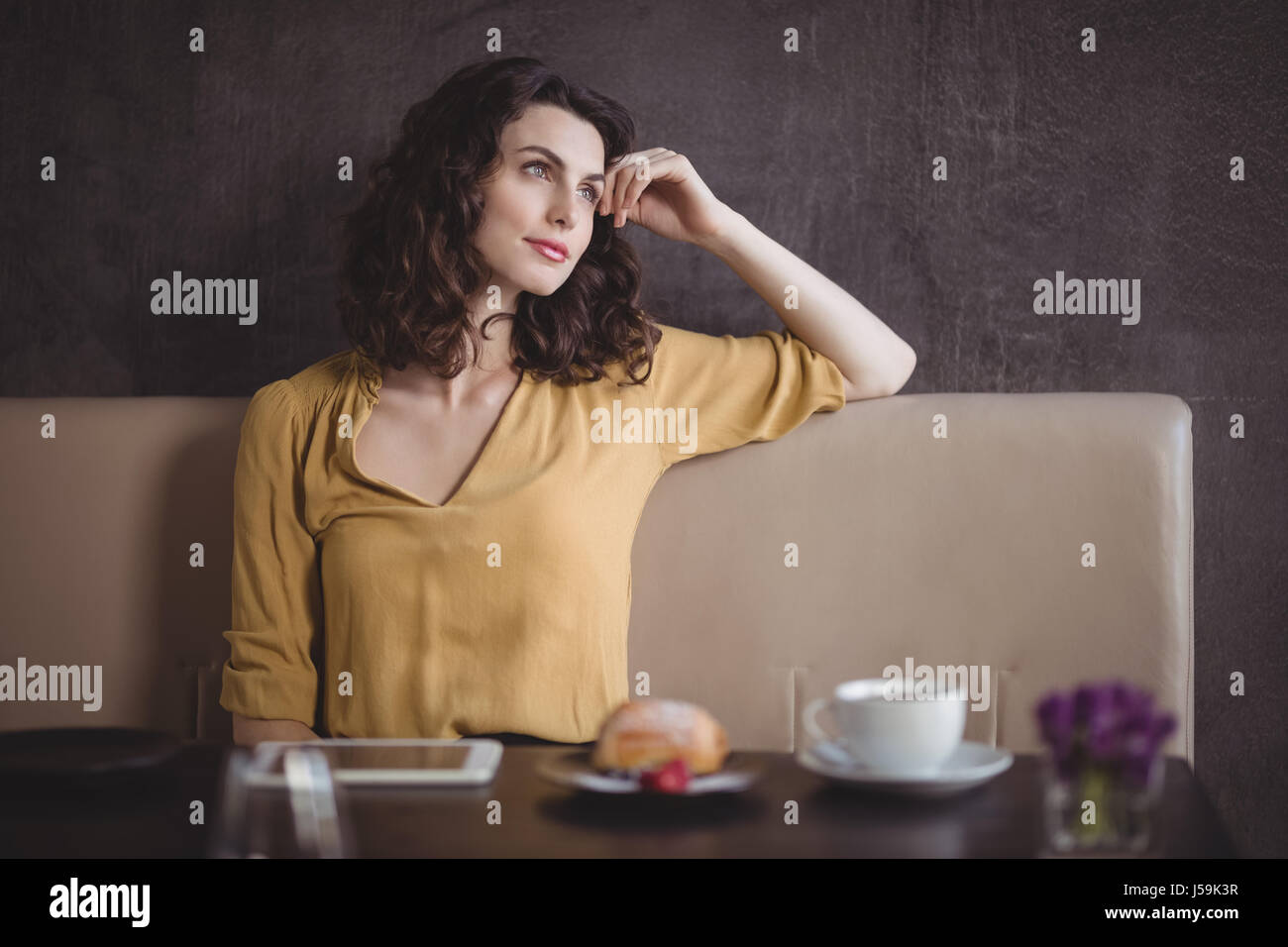 Thoughtful woman sitting in restaurant Stock Photo - Alamy