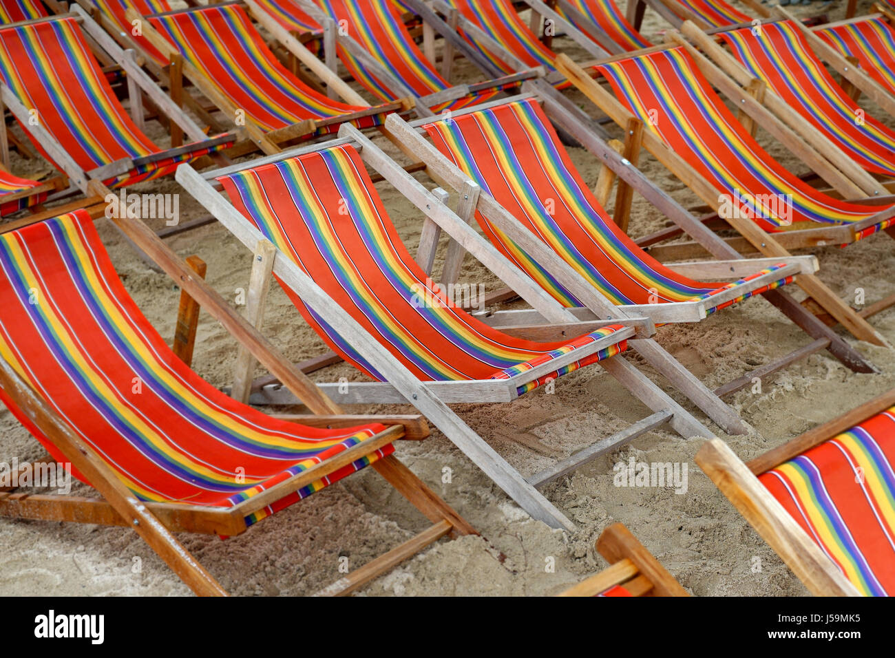 pile of relaxation sunbathing chairs on beach Stock Photo - Alamy