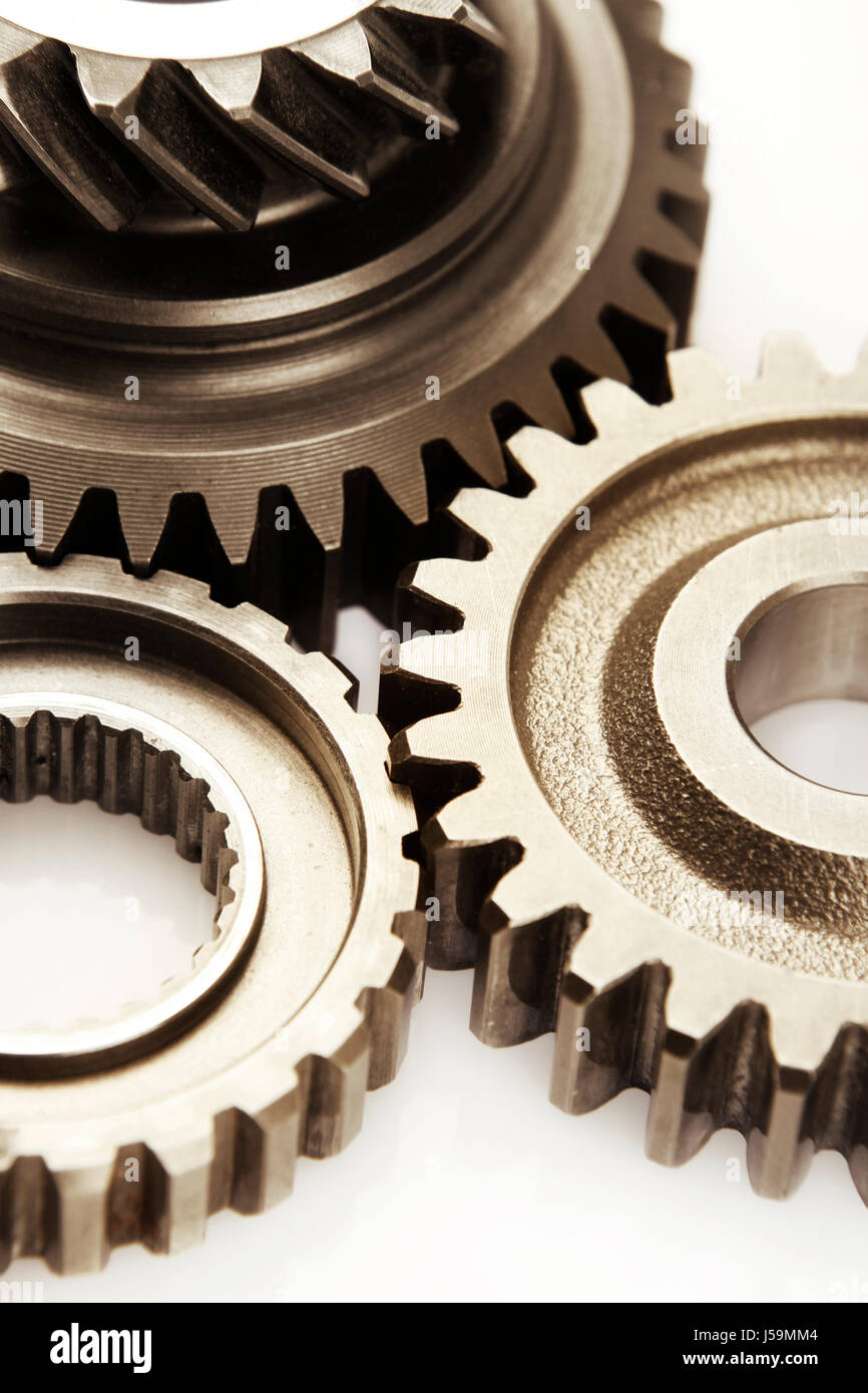 Metal cog gears joining together Stock Photo - Alamy
