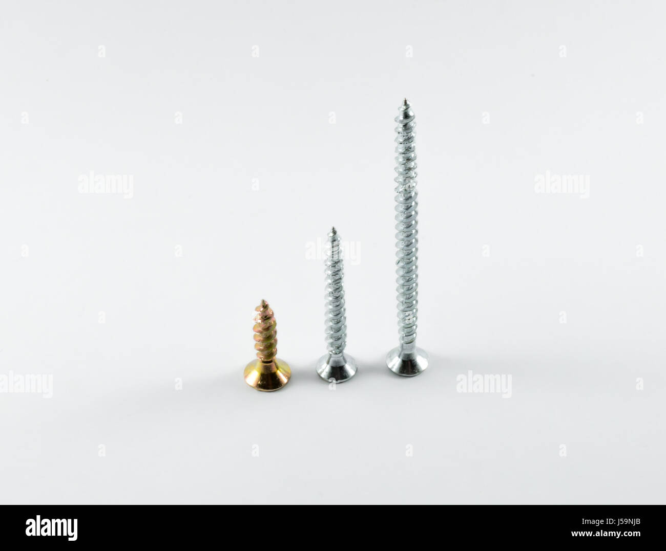 Three sized screws side-by-side Stock Photo - Alamy
