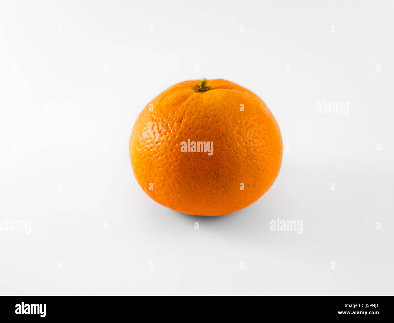 A single tangerine on a white background Stock Photo - Alamy