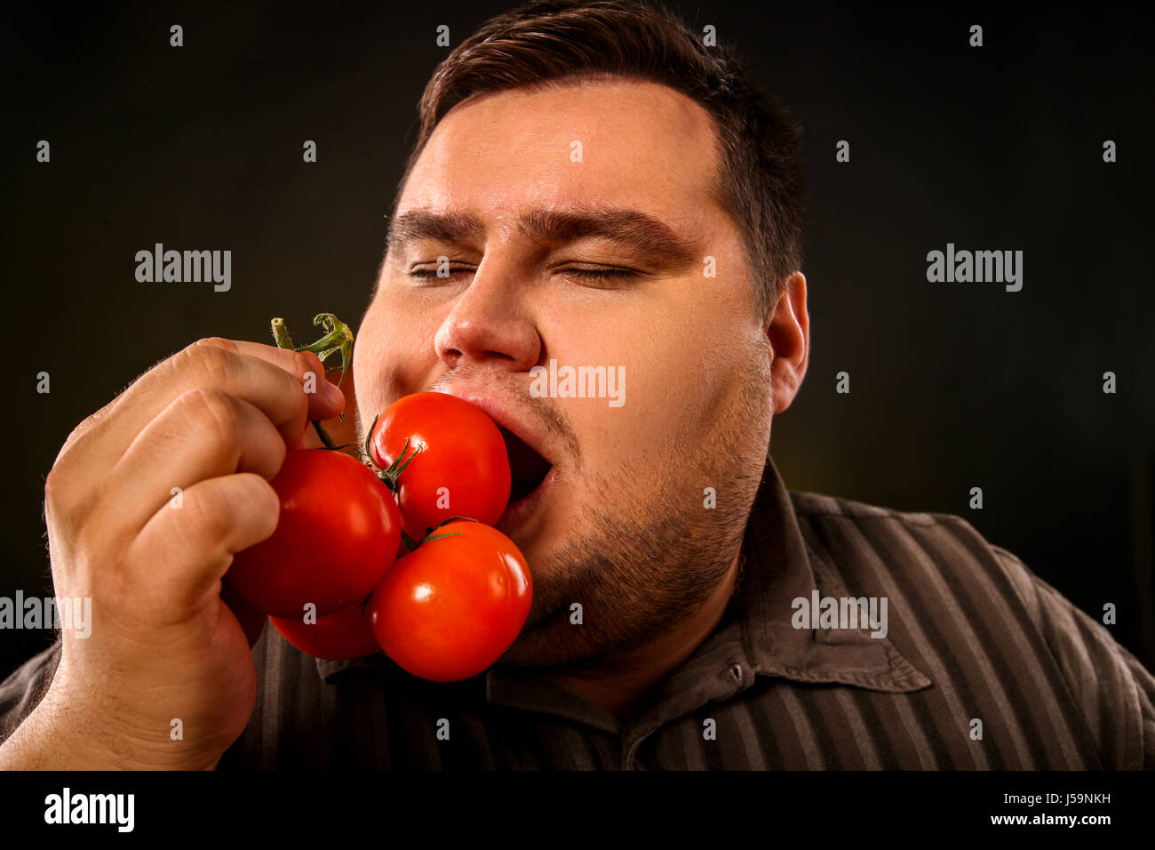 Diet fat man eating healthy food . Healthy breakfast with vegetables ...