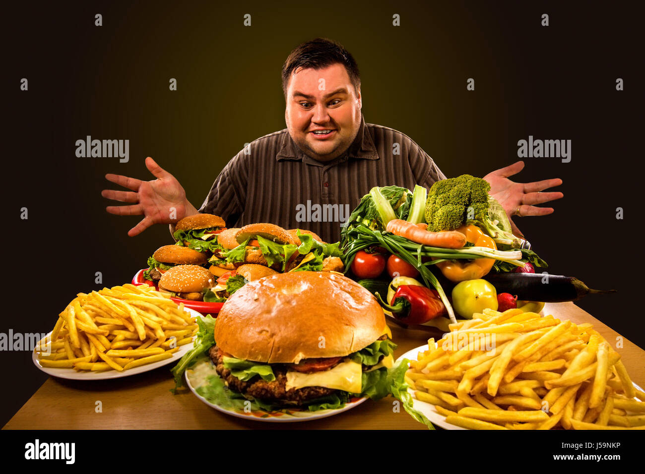 Diet fat man makes choice between healthy and unhealthy food Stock ...