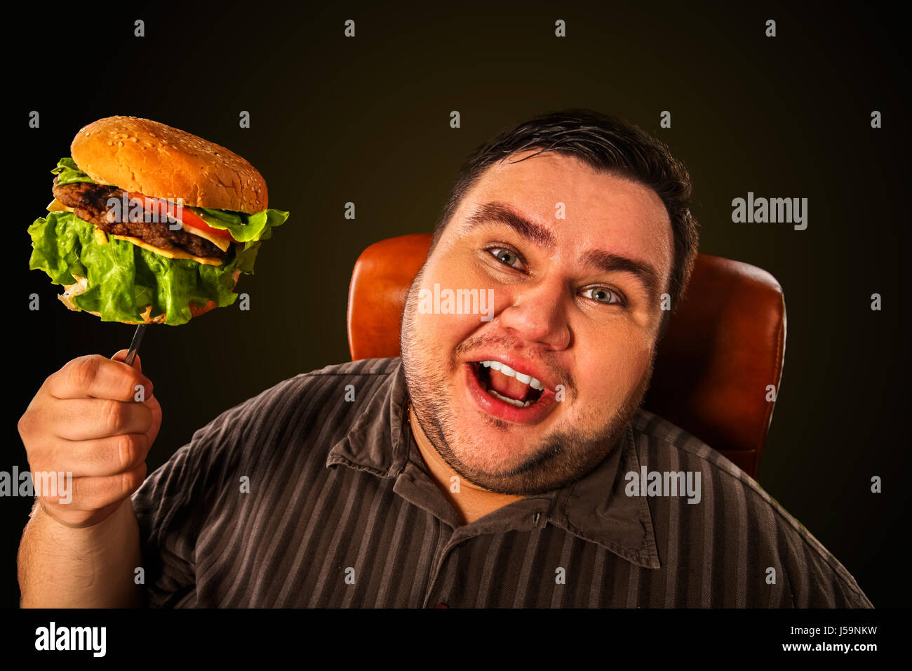 Fat man eating fast food hamberger. Breakfast for overweight person ...