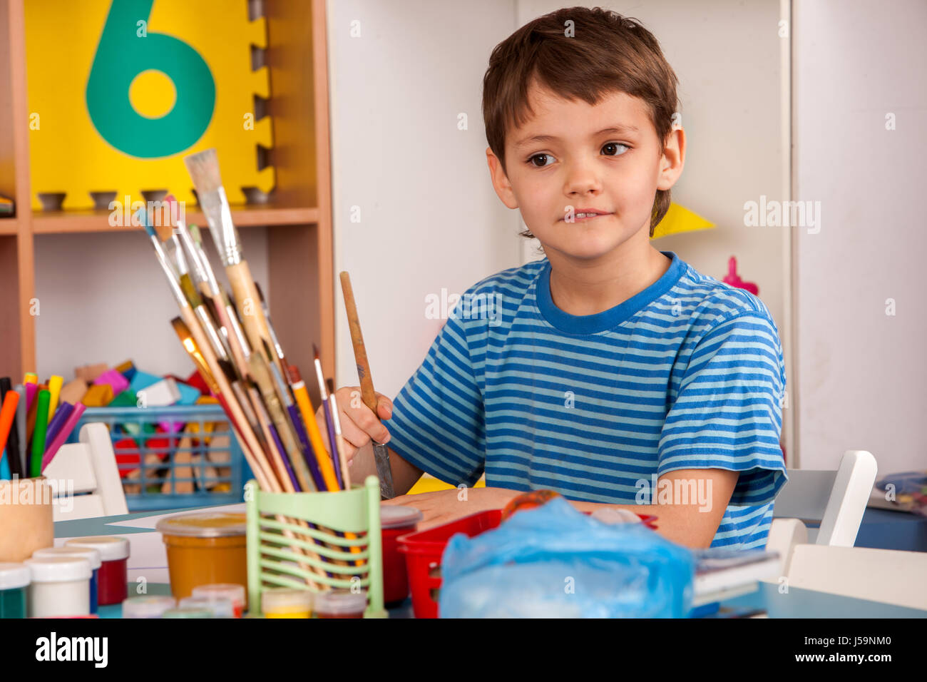 Small students boy painting in art school class Stock Photo - Alamy