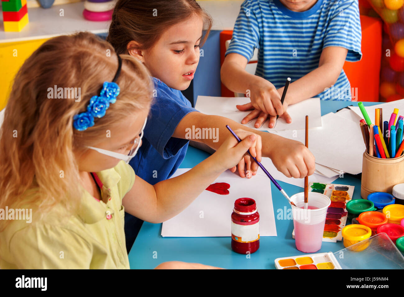 Small students girl painting in art school class Stock Photo - Alamy