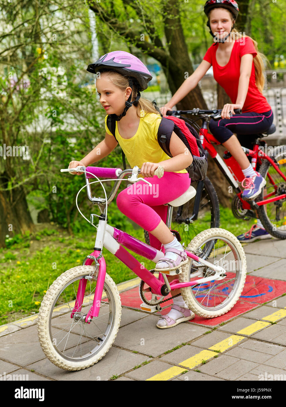 Bicycle path sign with children. Girls wearing helmet with rucksack ...