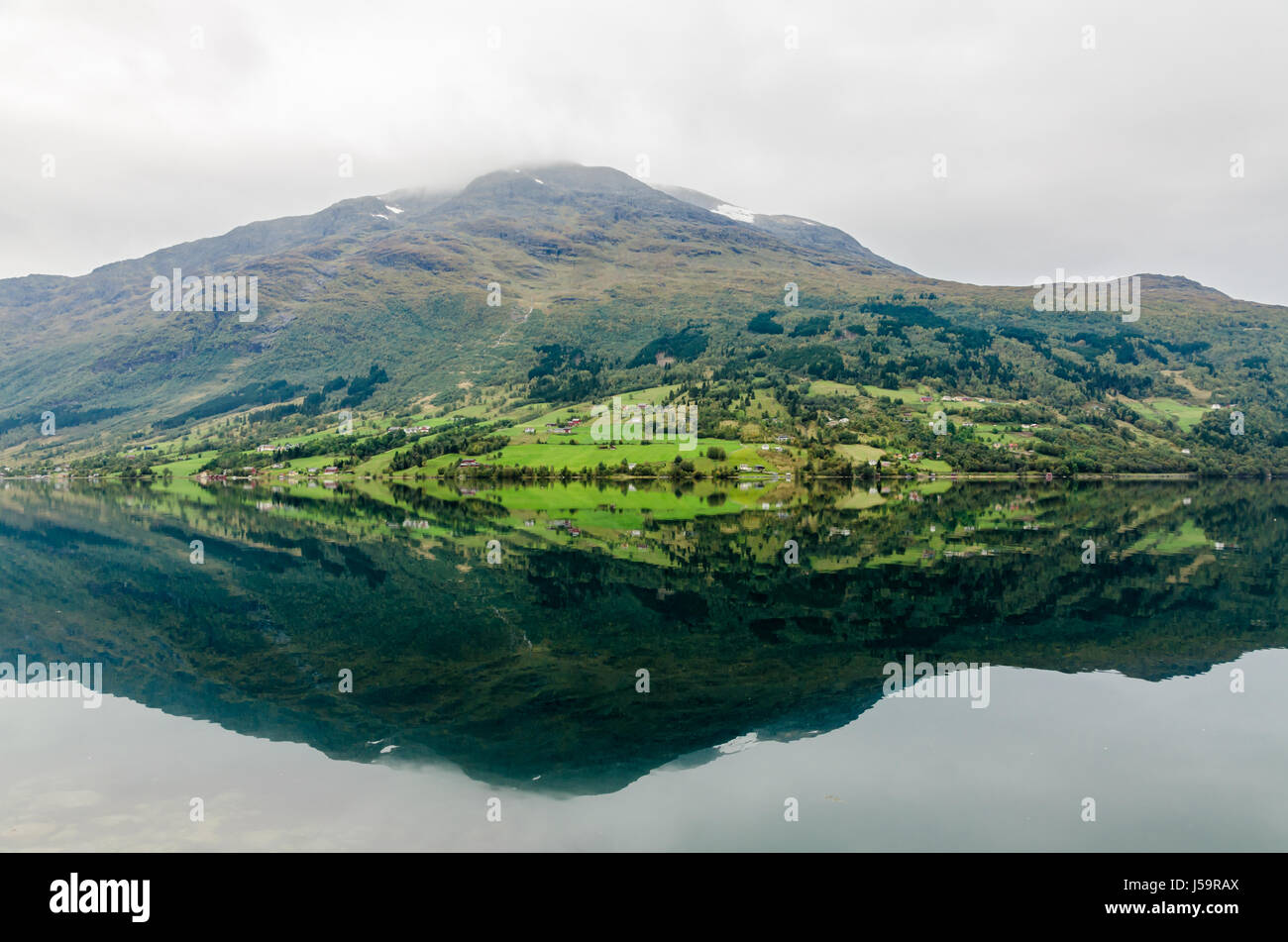 Reflection in Norway fjord at fall time Stock Photo - Alamy