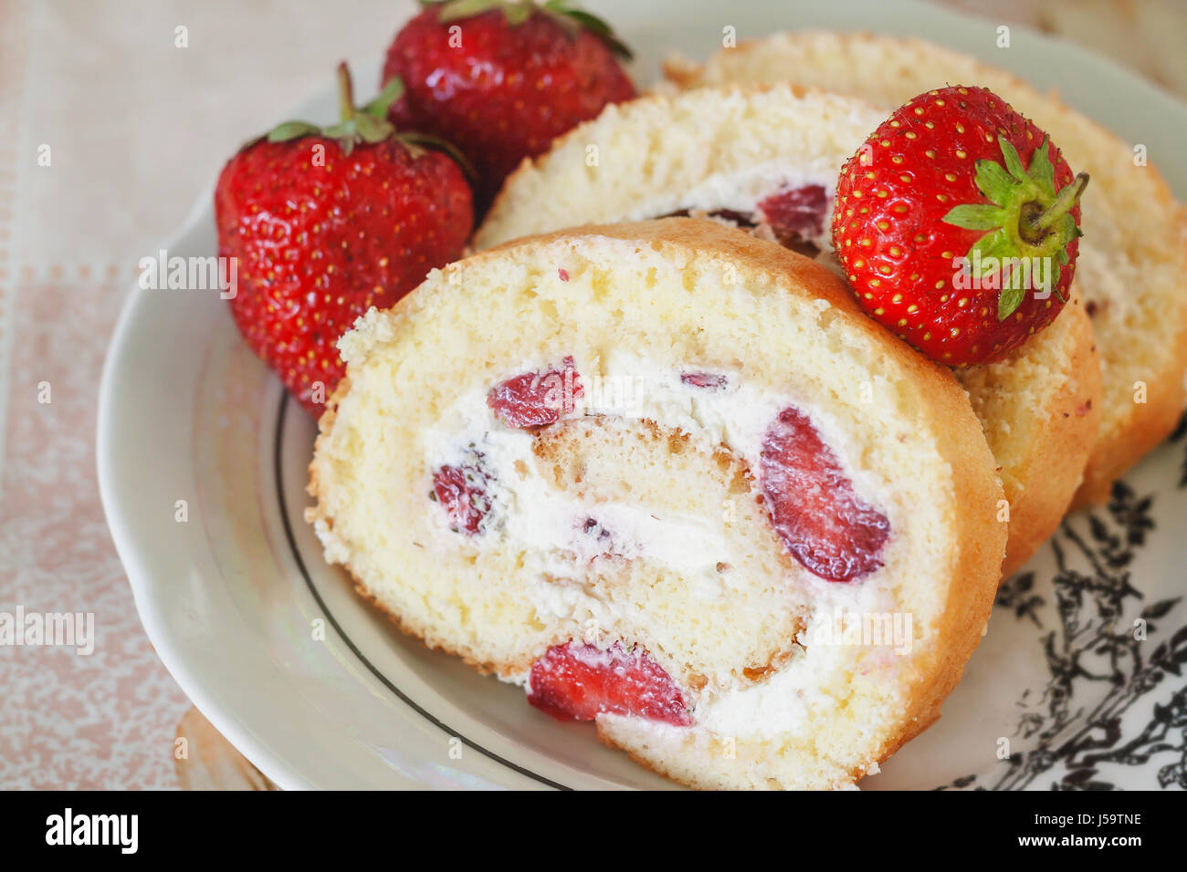 Sponge roulades with cream and fresh strawberries, close-up Stock Photo ...