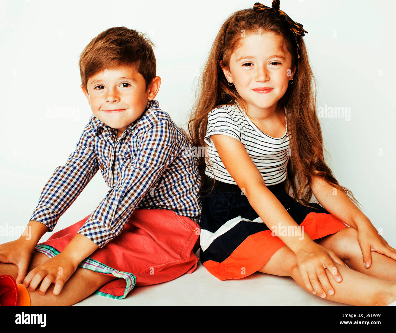 little cute boy and girl hugging playing on white background, ha Stock Photo - Alamy