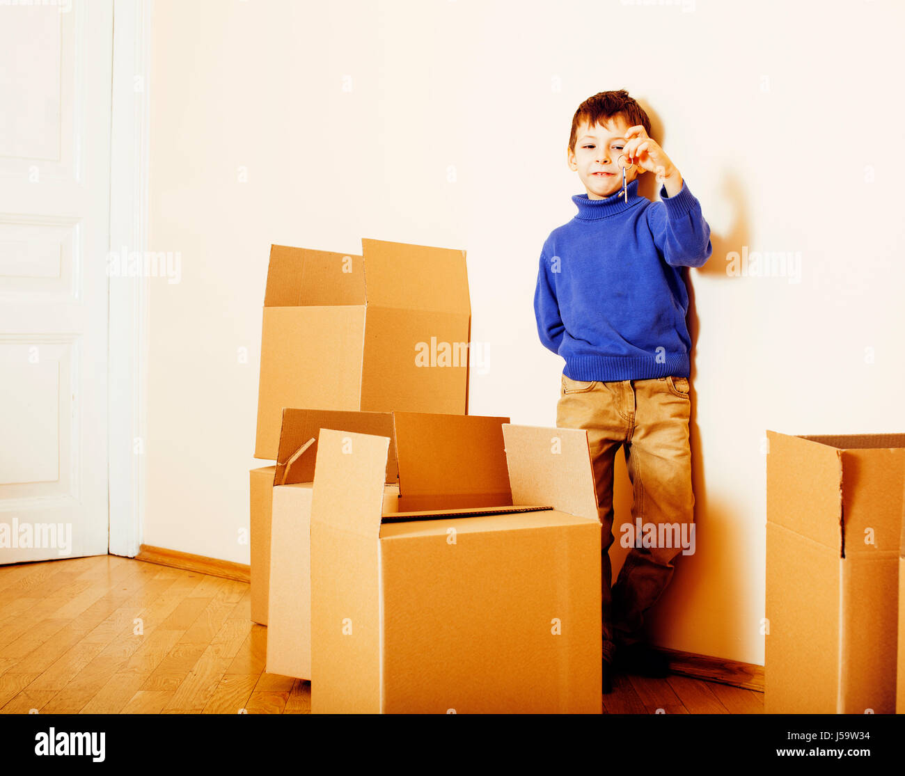 little cute boy in empty room, remoove to new house. home alone emong ...