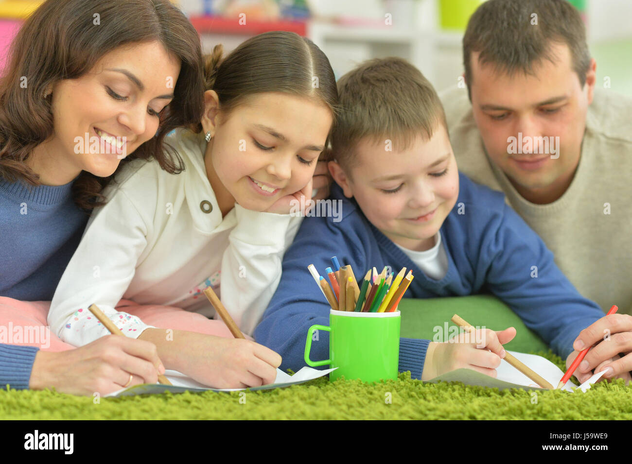 Children draw with their parents Stock Photo - Alamy