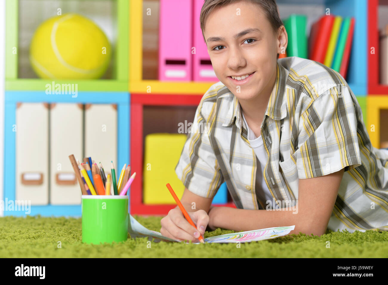 Boy drawing with pencils Stock Photo - Alamy