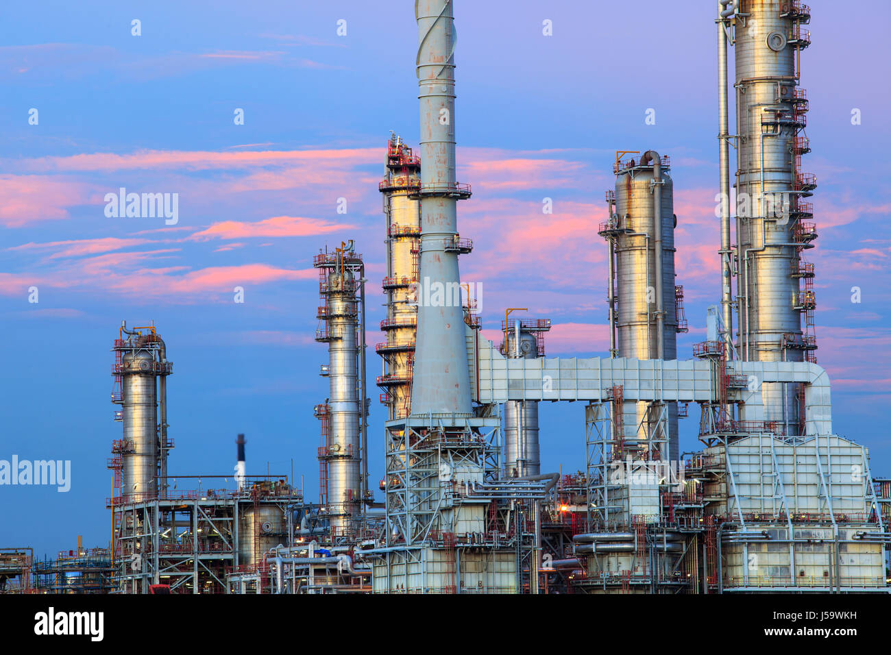 oil refinery chimney in heavy industry estate against beautiful dusky ...