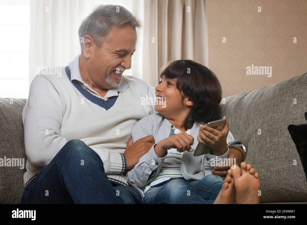 Happy grandfather and grandson using cell phone Stock Photo - Alamy