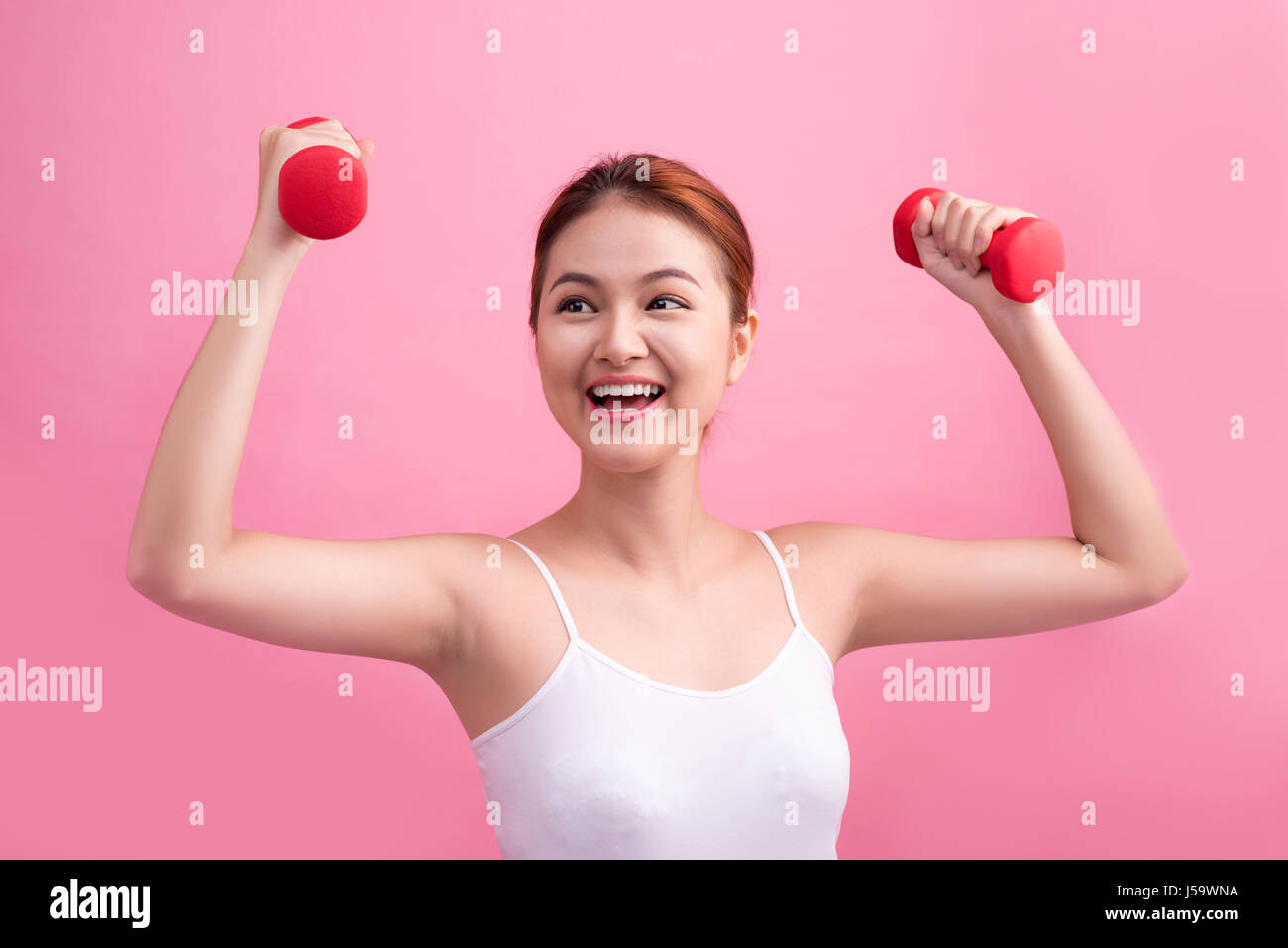 Woman Lifting Weights. Fitness woman lifting weights smiling happy on ...