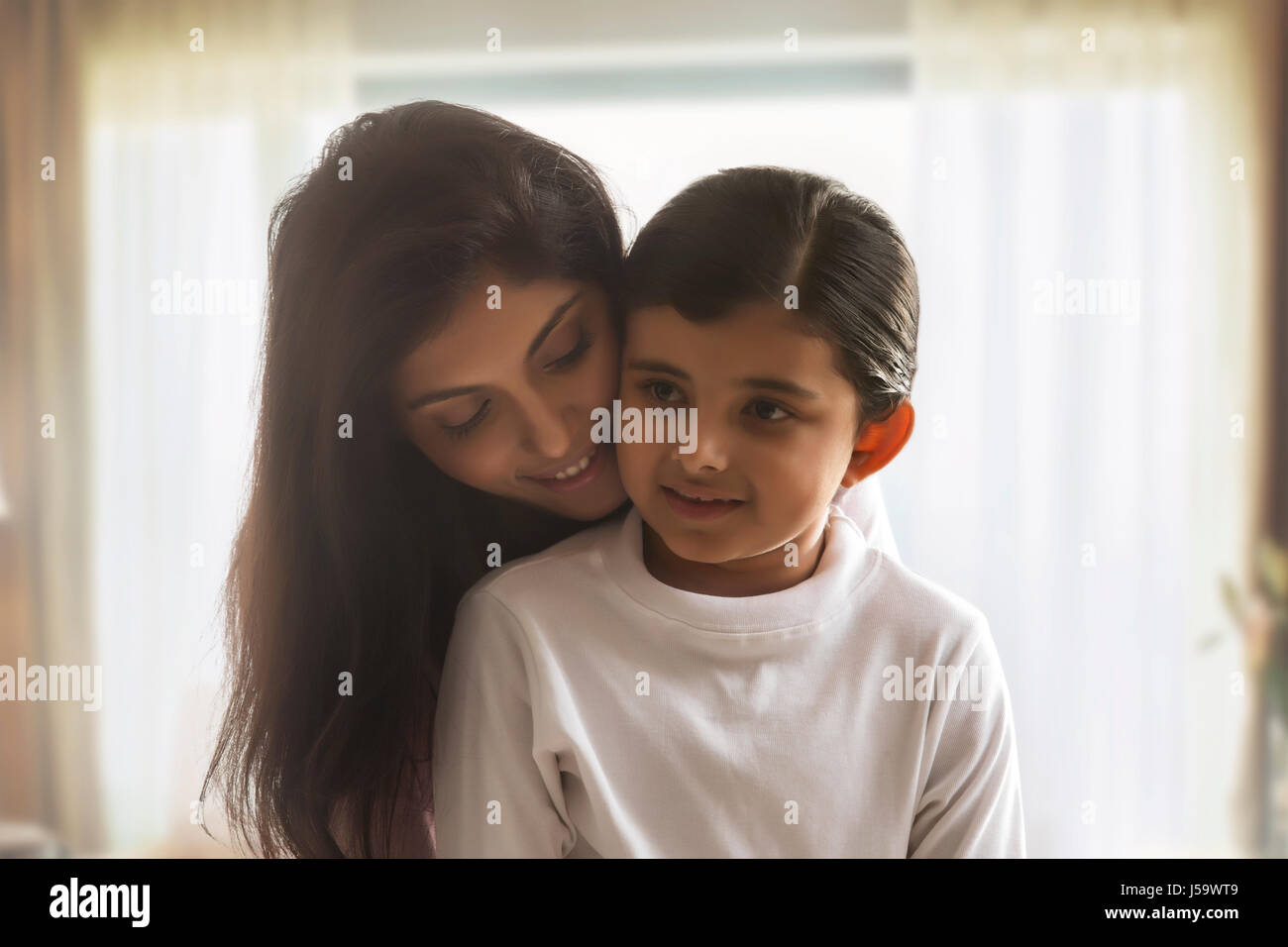 Portrait of mother hugging daughter Stock Photo - Alamy