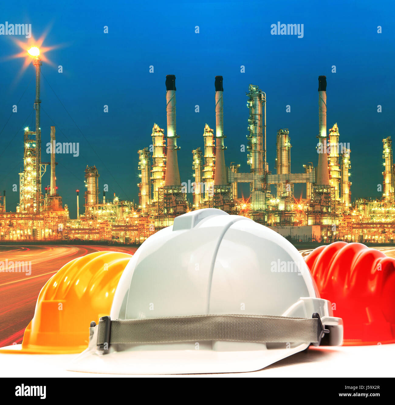 safety helmet against beautiful lighting of oil refinery plant in ...