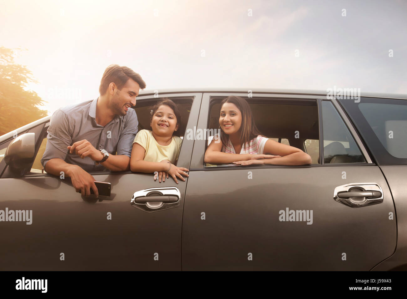 Family looking out car window during their road trip Stock Photo - Alamy