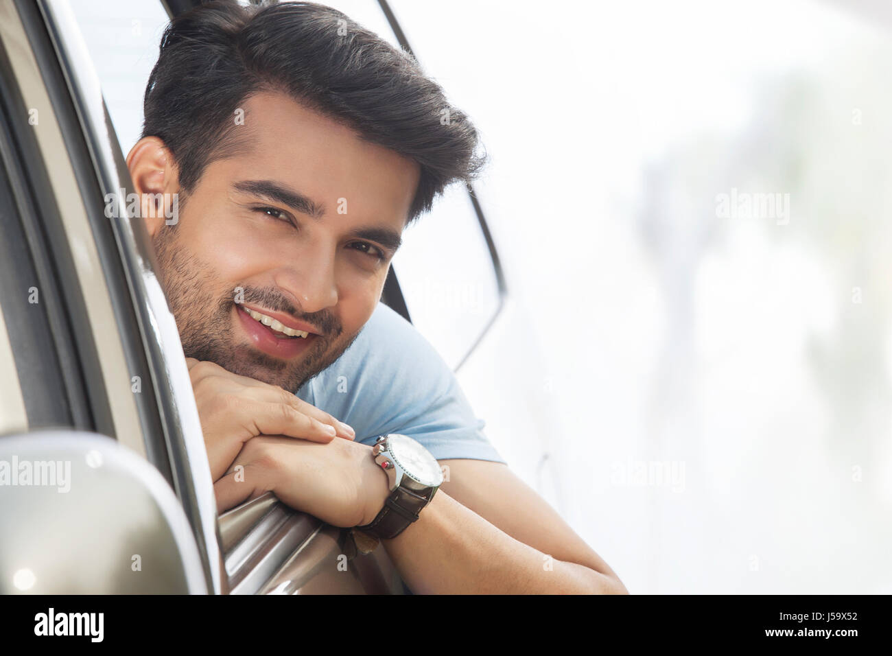 Young man looking out of car window Stock Photo - Alamy