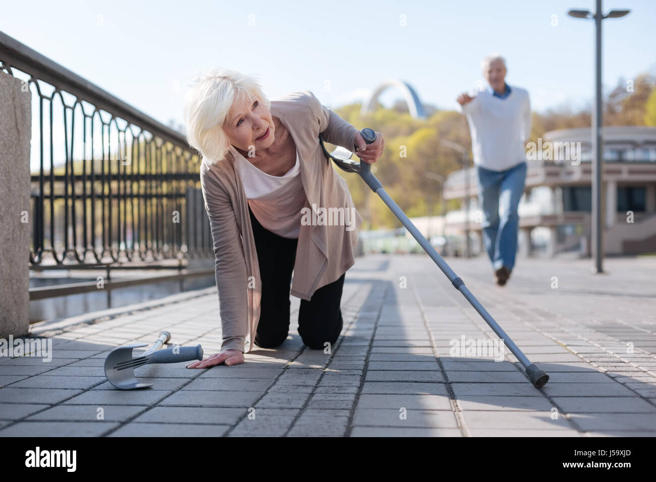 Powerless woman falling in the street Stock Photo - Alamy