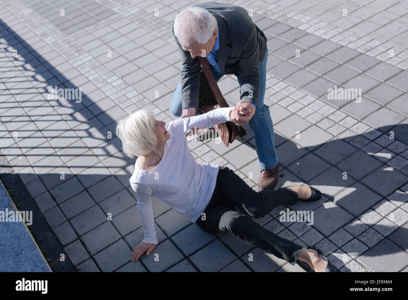 Pleasant woman tumbling over outdoors Stock Photo - Alamy