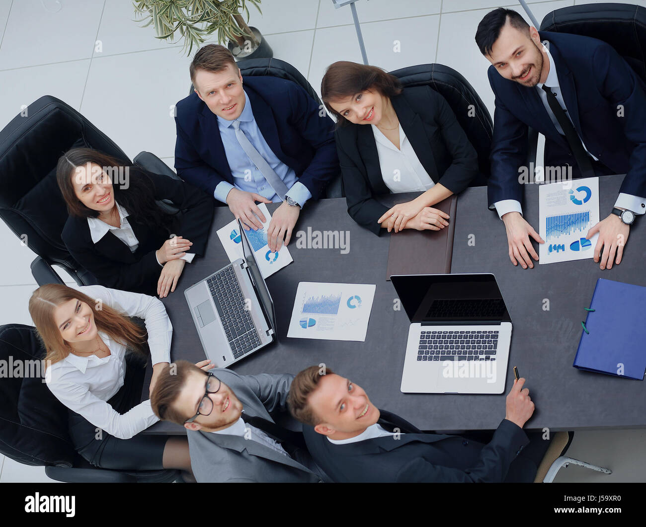 meeting around a table in an office Stock Photo - Alamy