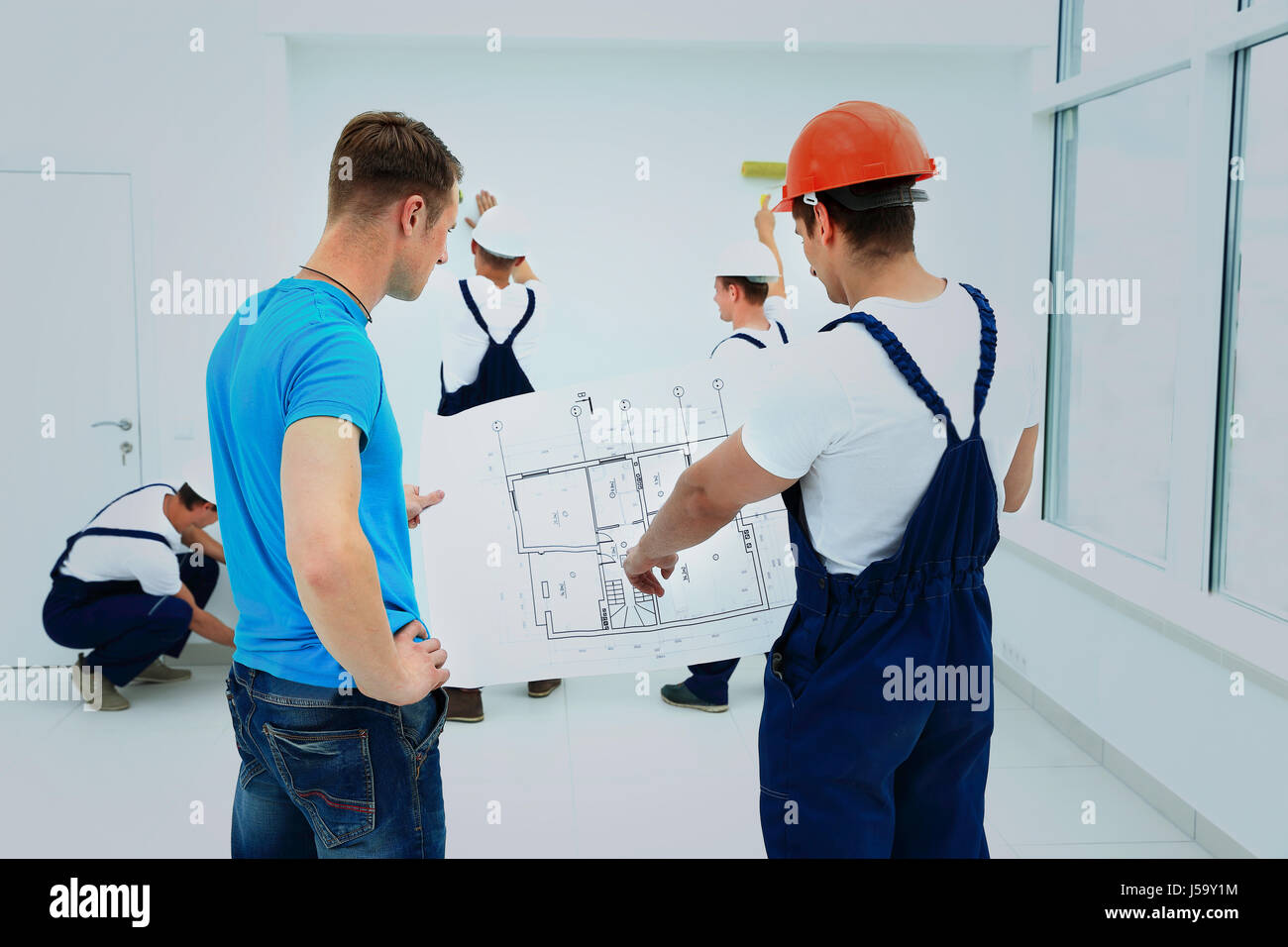 Architect and client discussing the plan of the building Stock Photo ...