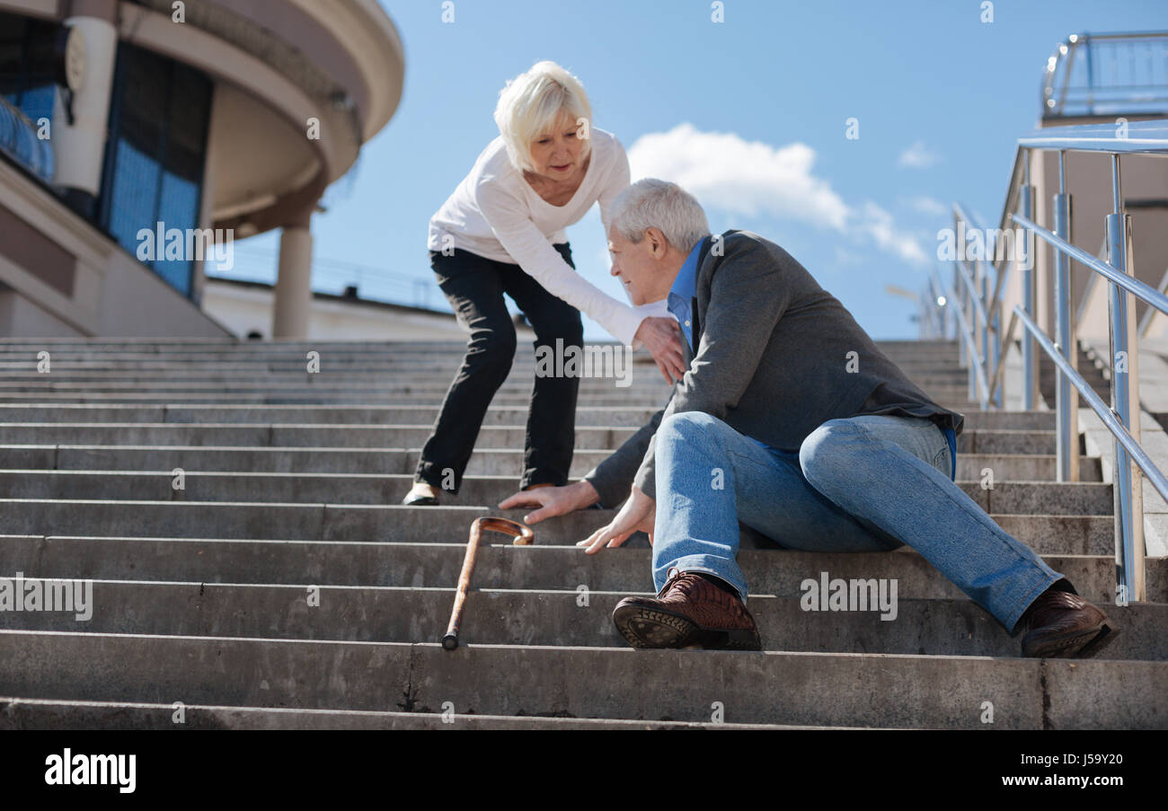Miserable man asking for help on stairs Stock Photo - Alamy