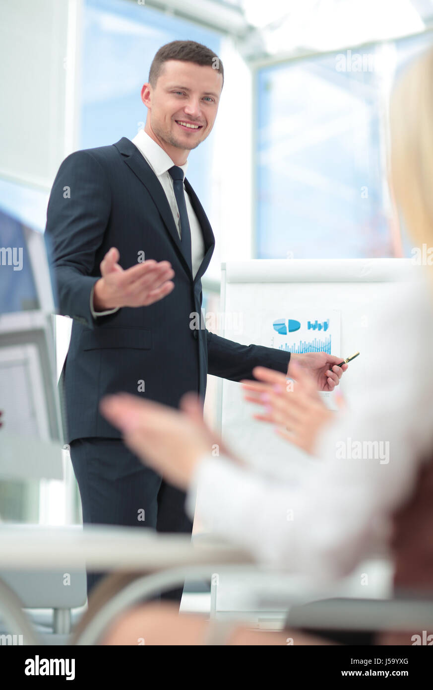 Attractive man making a business presentation to a group Stock Photo ...