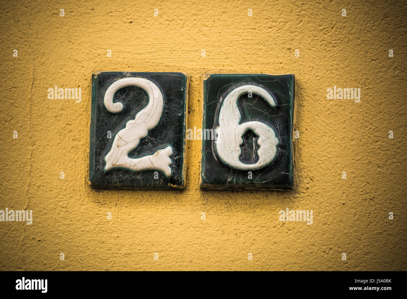 Number twenty six in raised figures on plaster wall Stock Photo - Alamy